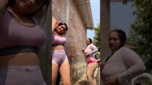 Two Beautiful young girls having shower in public dressed in white clothes