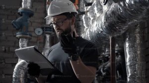 Plumber in technical room speaks in the speaker phone audio message