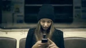 Teen girl rides the subway at night and used smartphone | Video Footage | Shutterstock