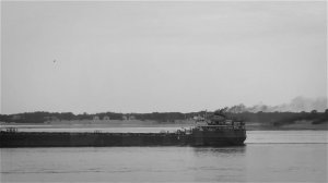 Barge is floating on the river.